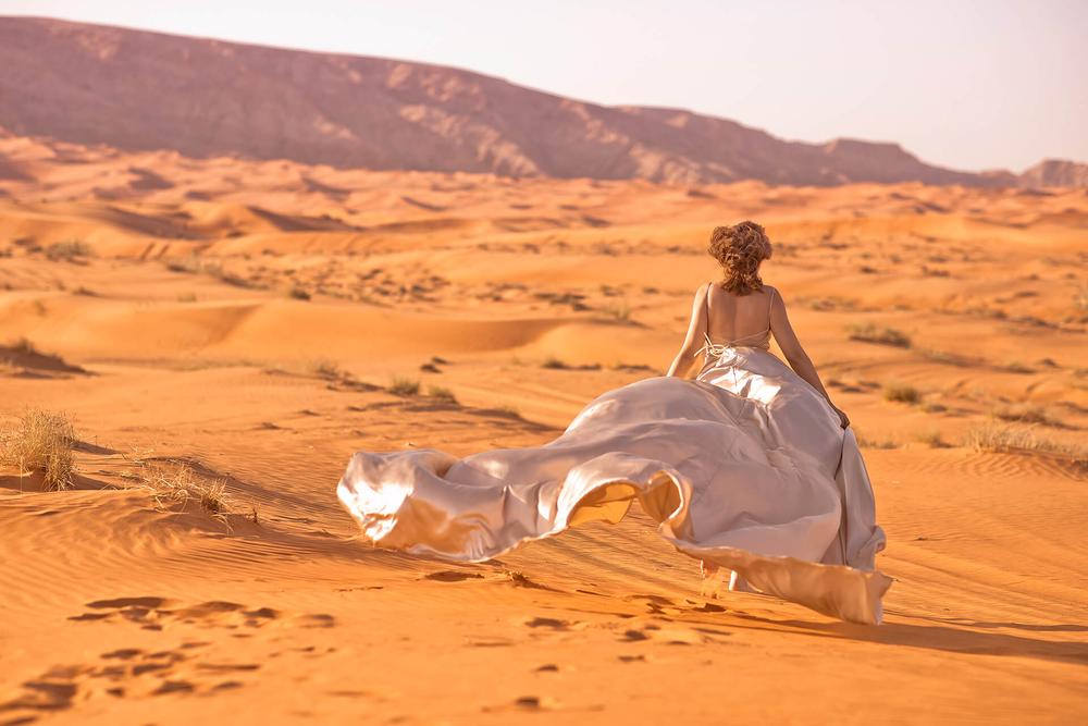 Maternity and family desert photo shoot in a desert with a flying dress